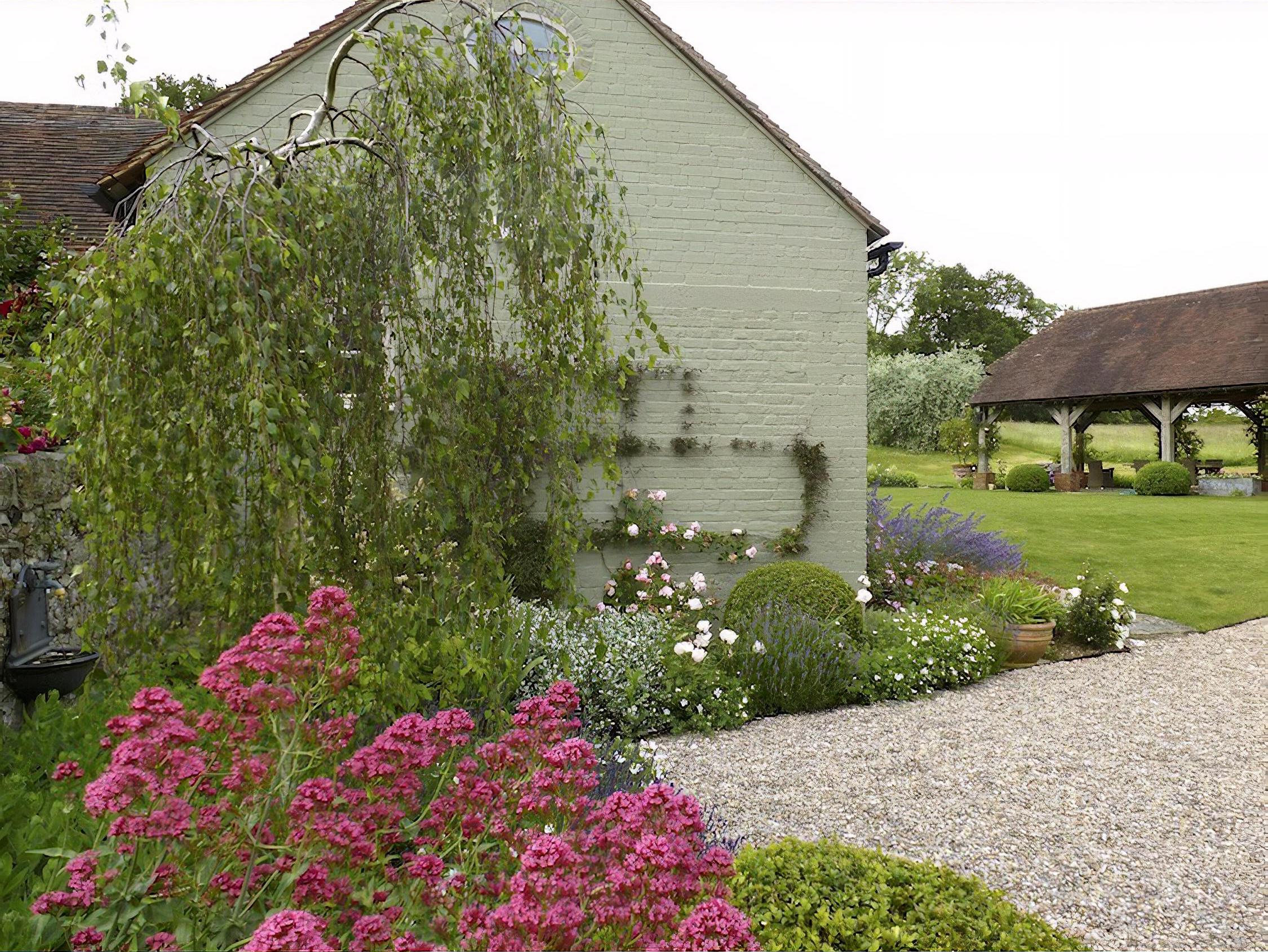 Converted farm courtyard garden by London garden designer Claudia de Yong